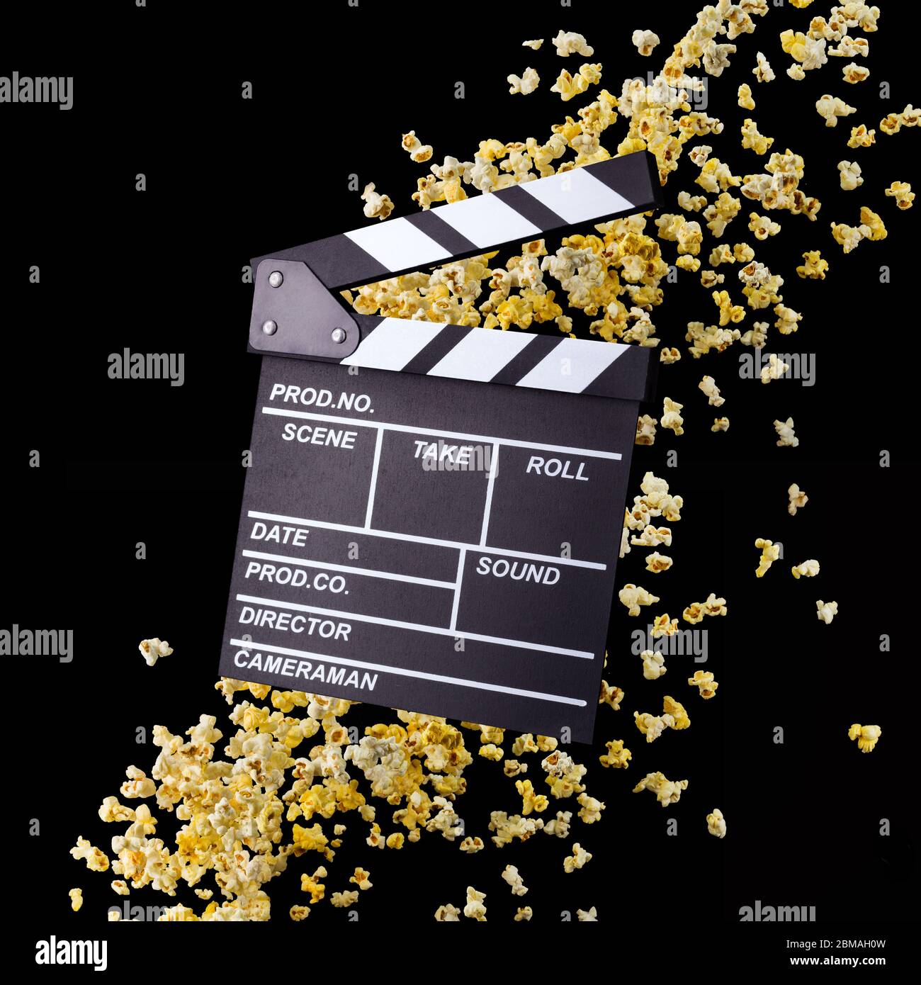 Flying popcorn and film clapper board isolated on black background ...