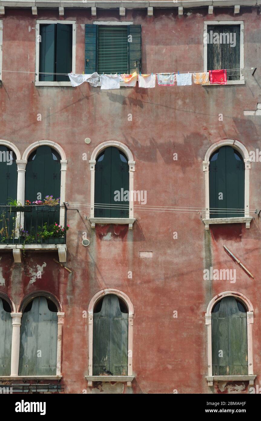 Building frontage with balcony and arched windows in Venice, Italy ...