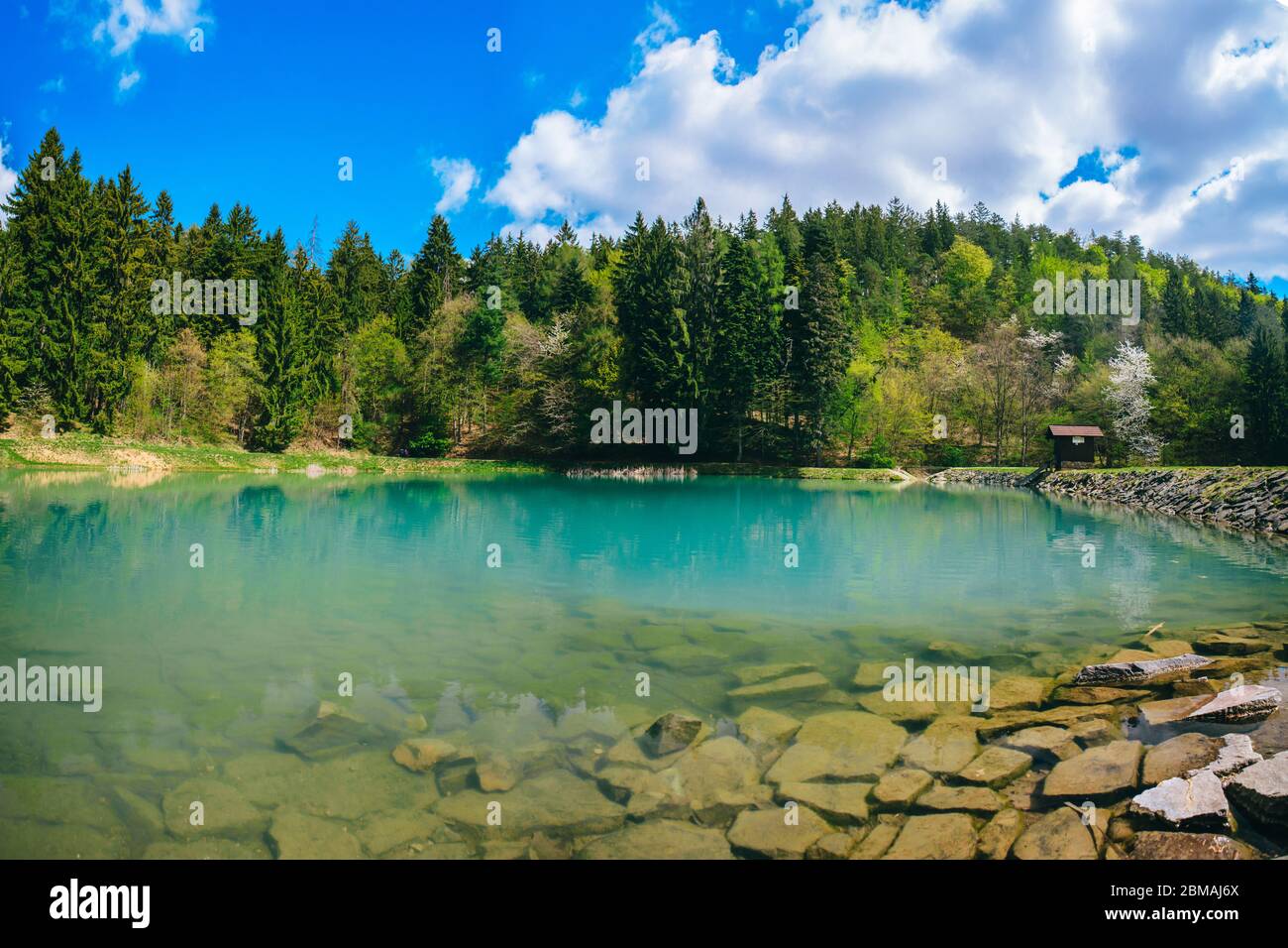 Turquoise color water in clear spring lake in sunny day. Wonderful ...