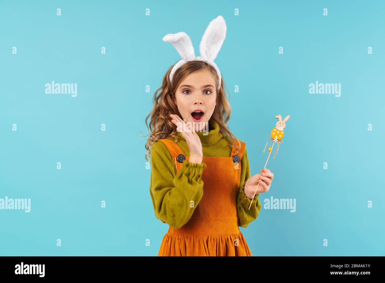 Image of a cute shocked surprised young girl child in easter holiday ...