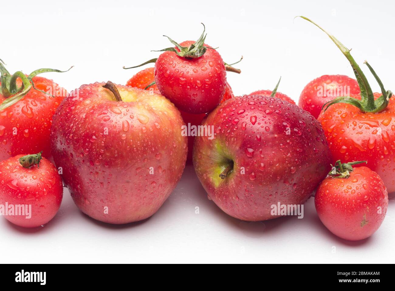 Tomatoes and apples, red fruits, for salads to eat raw, full of ...