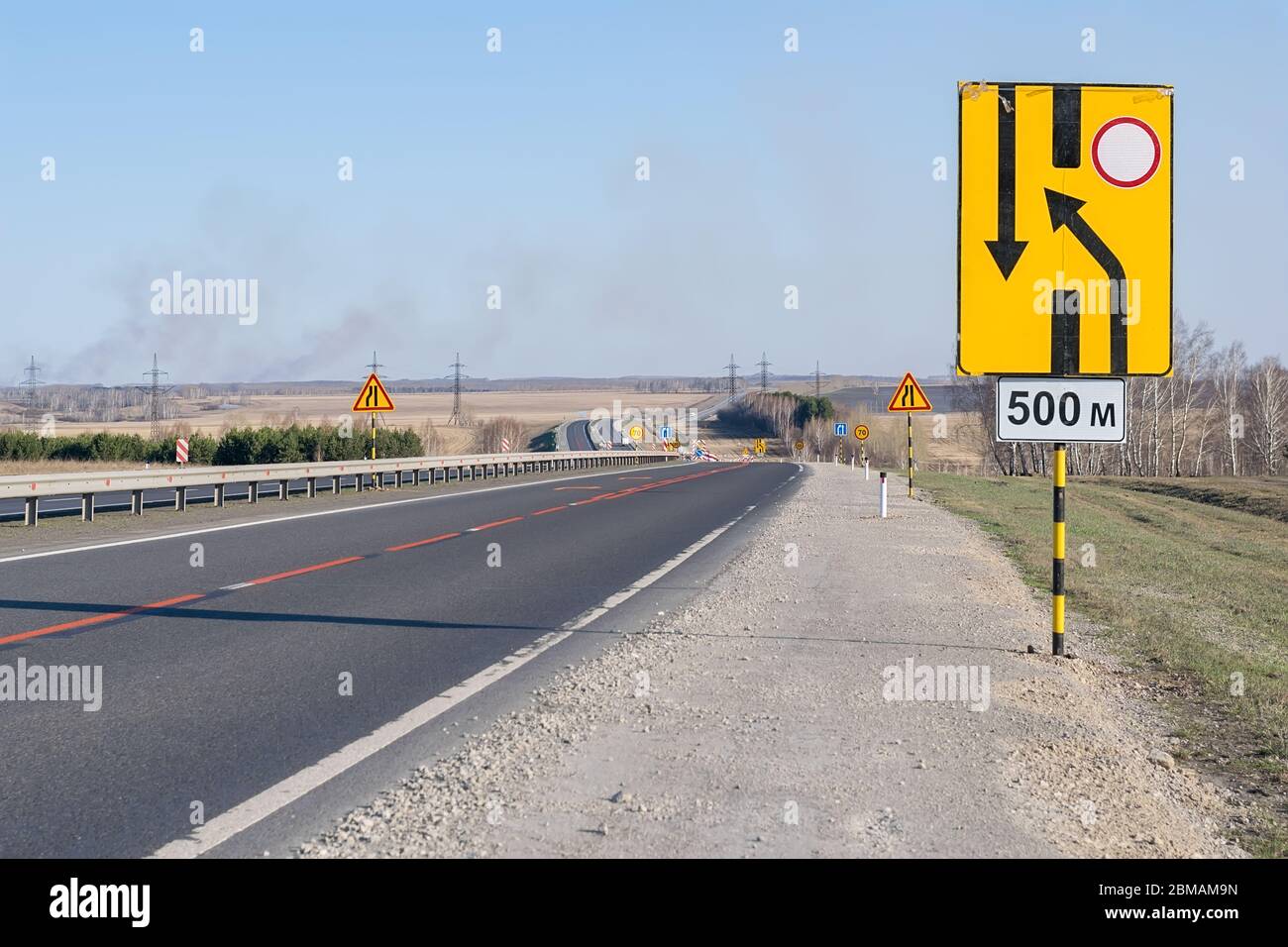 view of a large number of road repair warning signs on a country ...