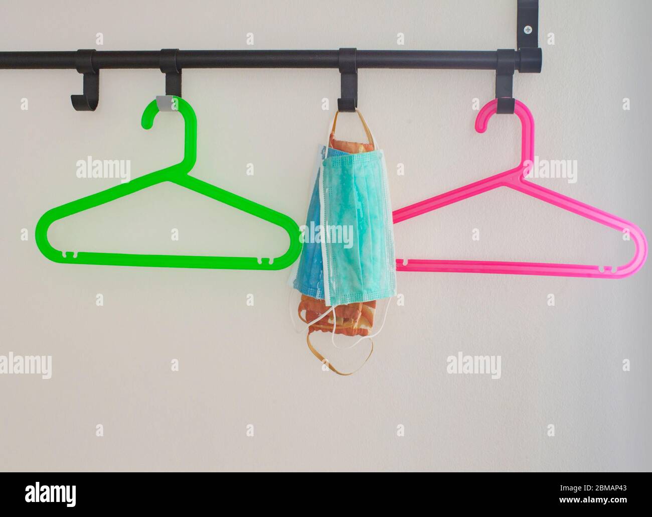 The Concept of Stay Home. Empty hanger and protective medical mask ...