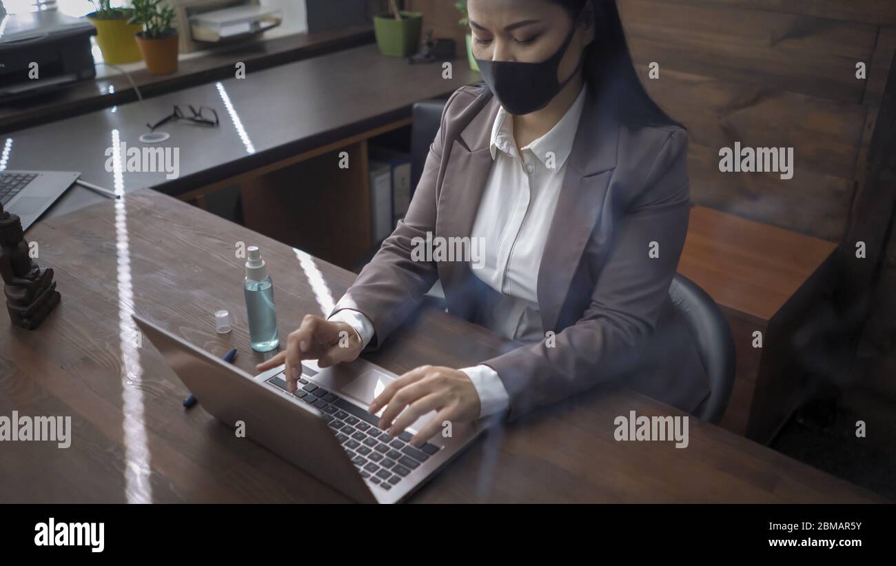 Business woman works computer sitting at desk with smoking incense ...