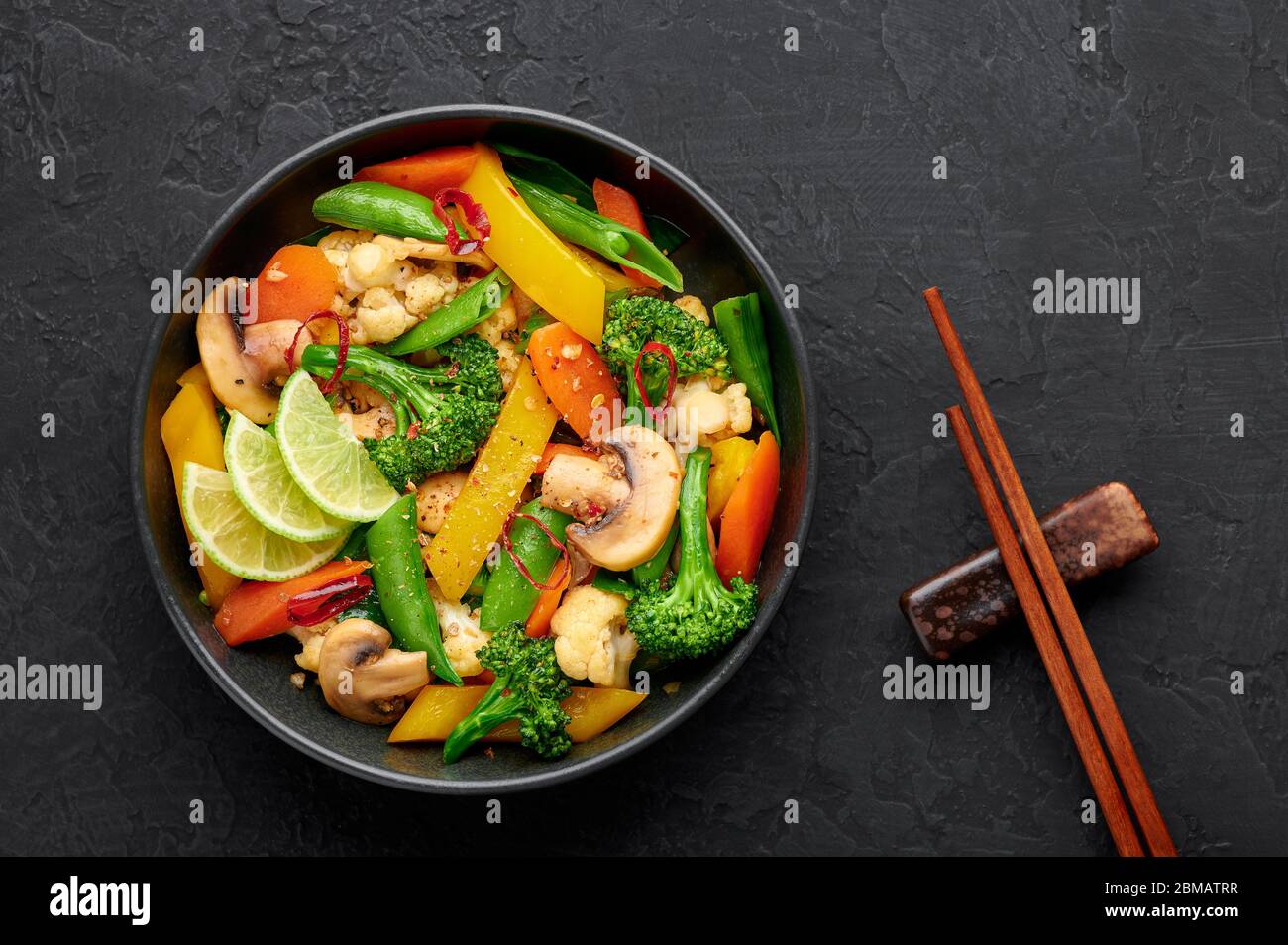 Pad Pak Ruam or Veg Thai Stir-Fried Vegetables in black bowl on dark ...