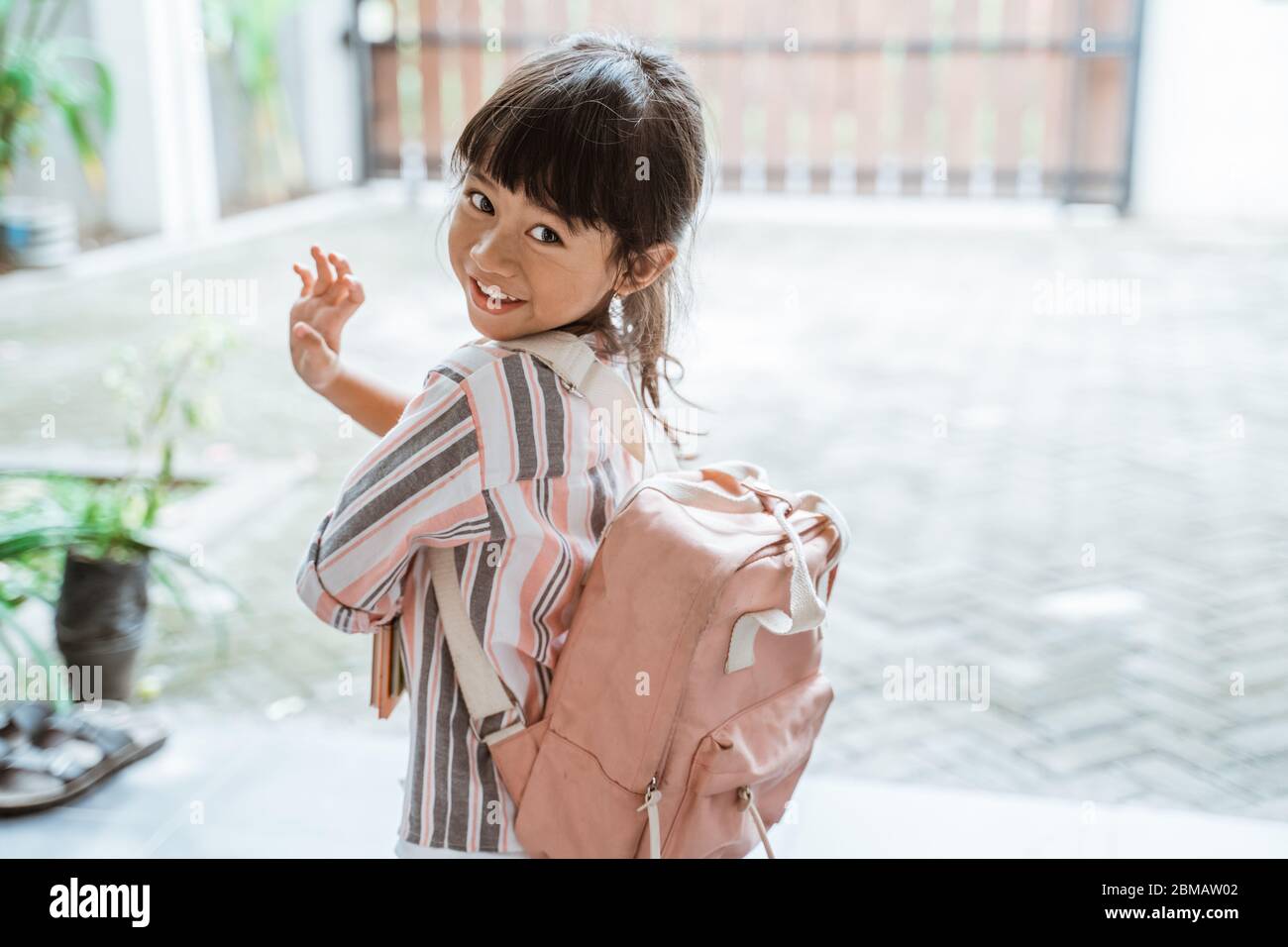 young kid waving goodbye before leaving to school in the morning Stock ...