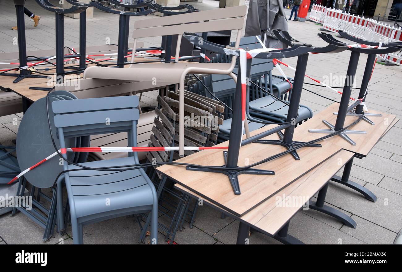 07 May 2020, Hamburg: In Hamburg, locked tables and chairs are stacked ...