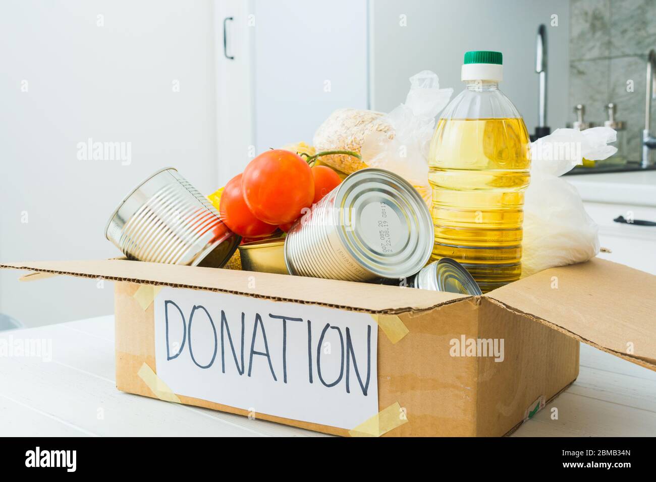 Donation food in cardboard box in kitchen. Help for people in ...