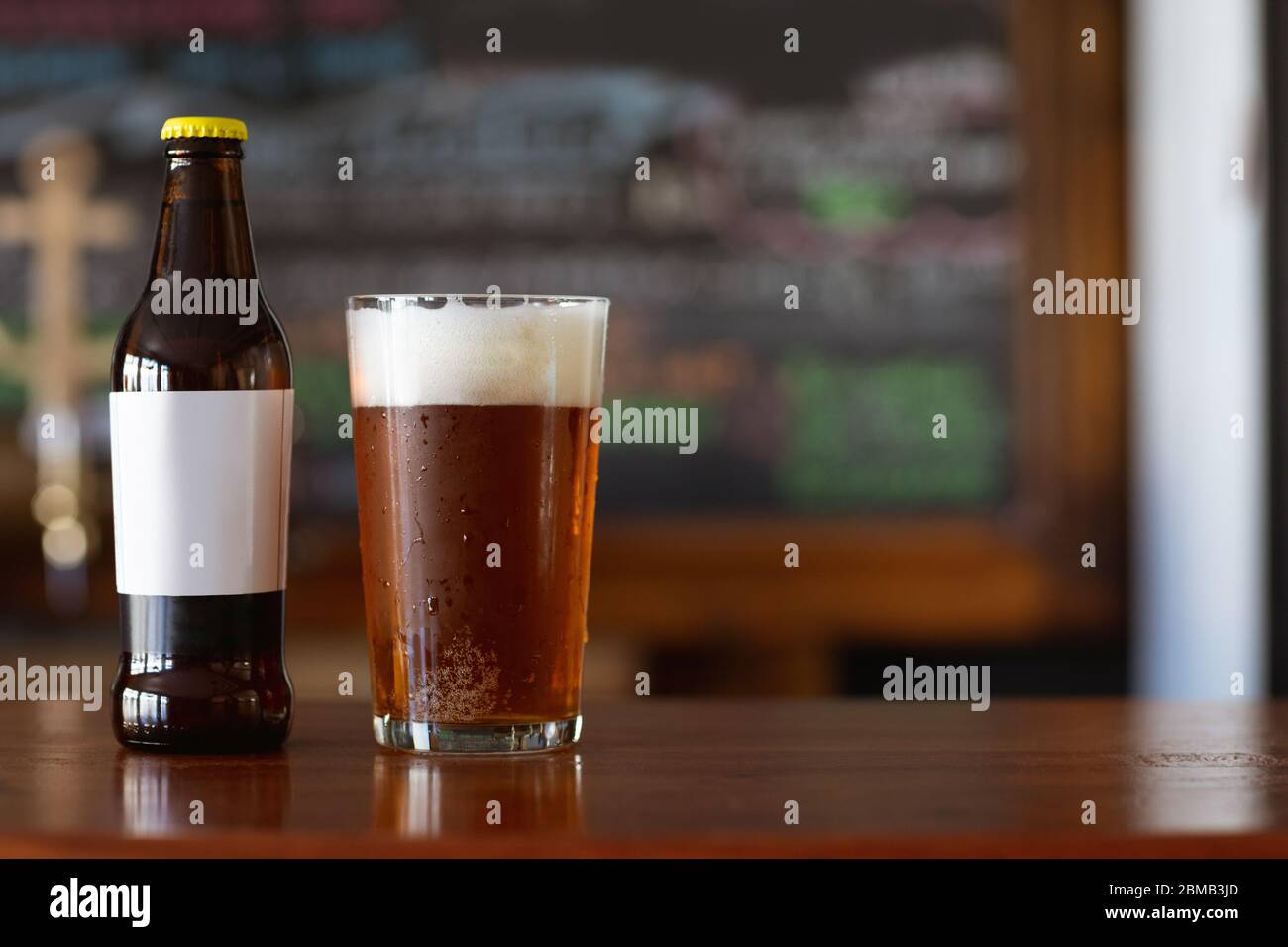 Pint of beer and its bottle in a brewery Stock Photo - Alamy