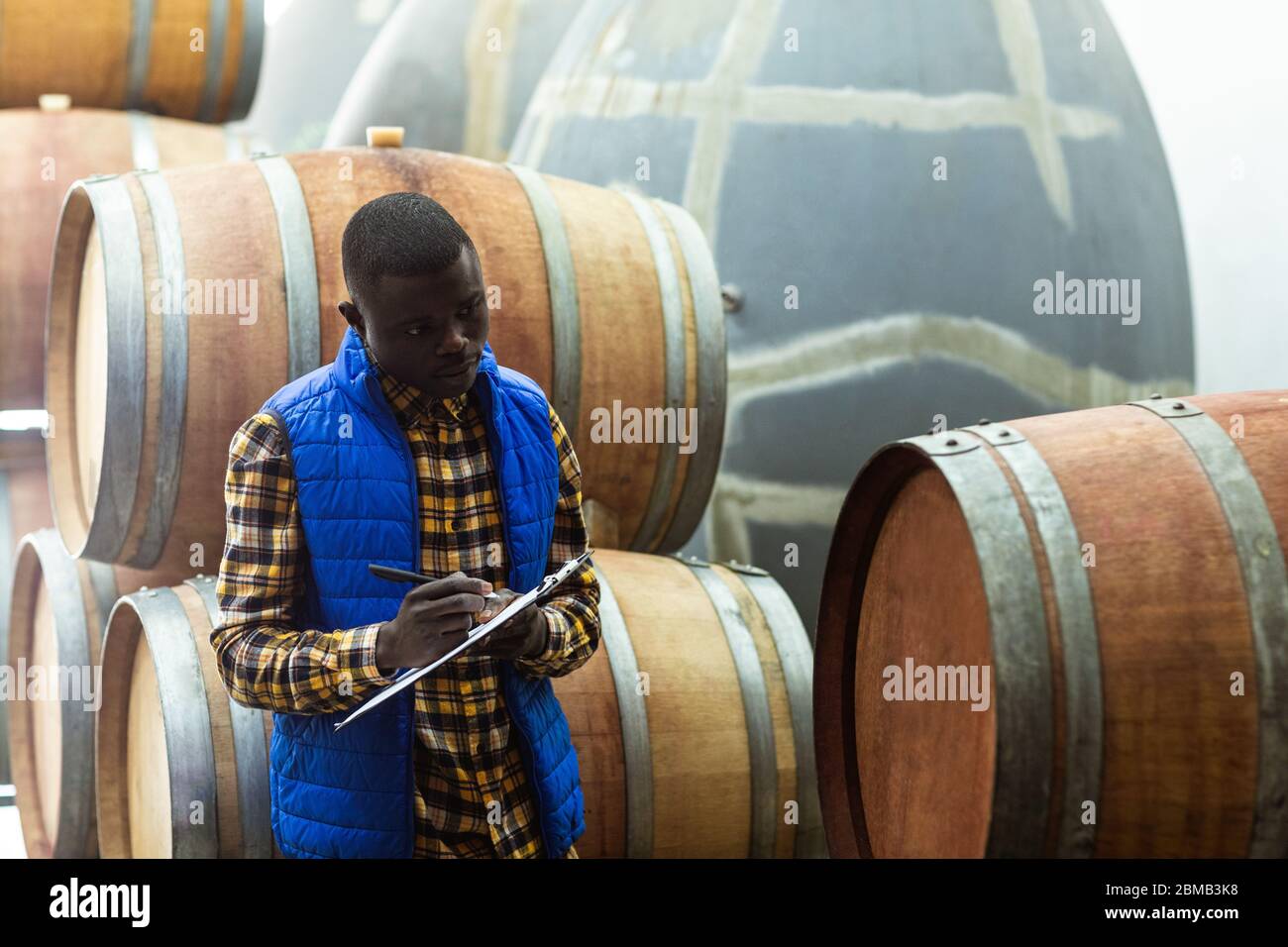 African American man counting tanks in a brewery Stock Photo - Alamy