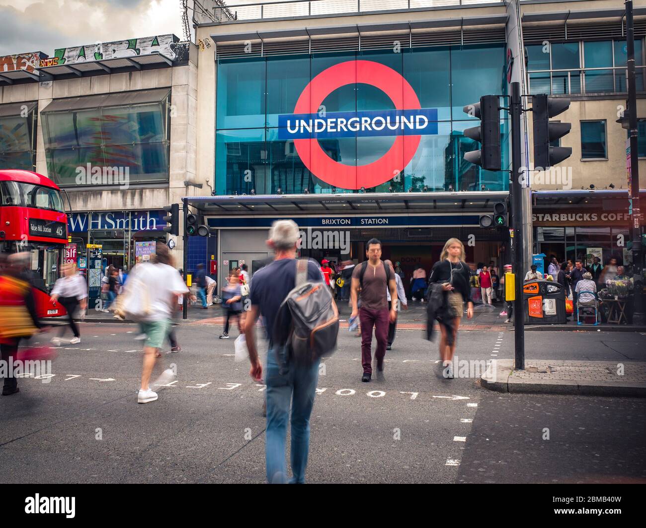 LONDON- Brixton Underground station. People crossing Brixton Road in ...