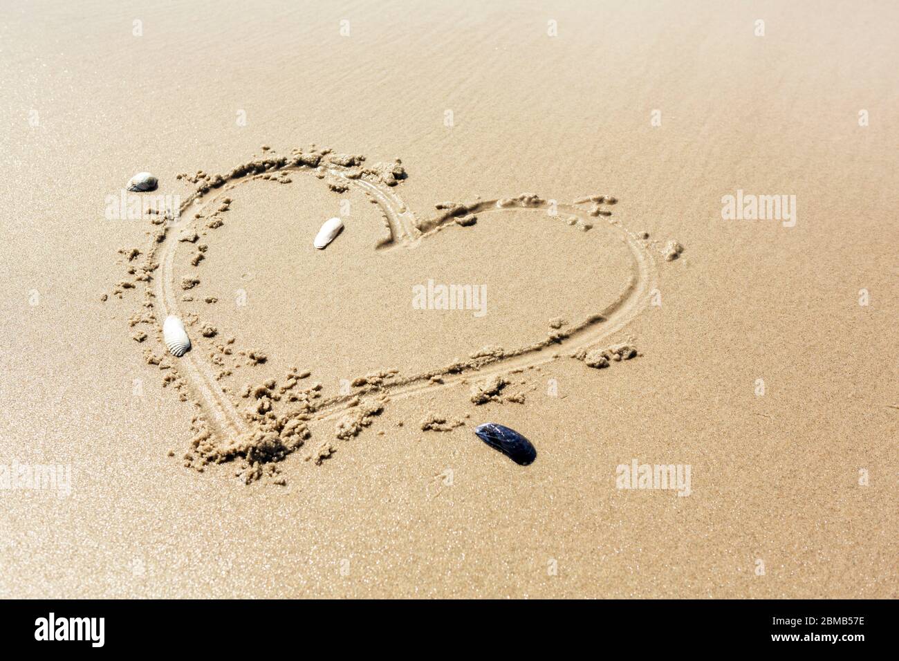 Heart, written on wet beach sand with copy space below in a conceptual ...