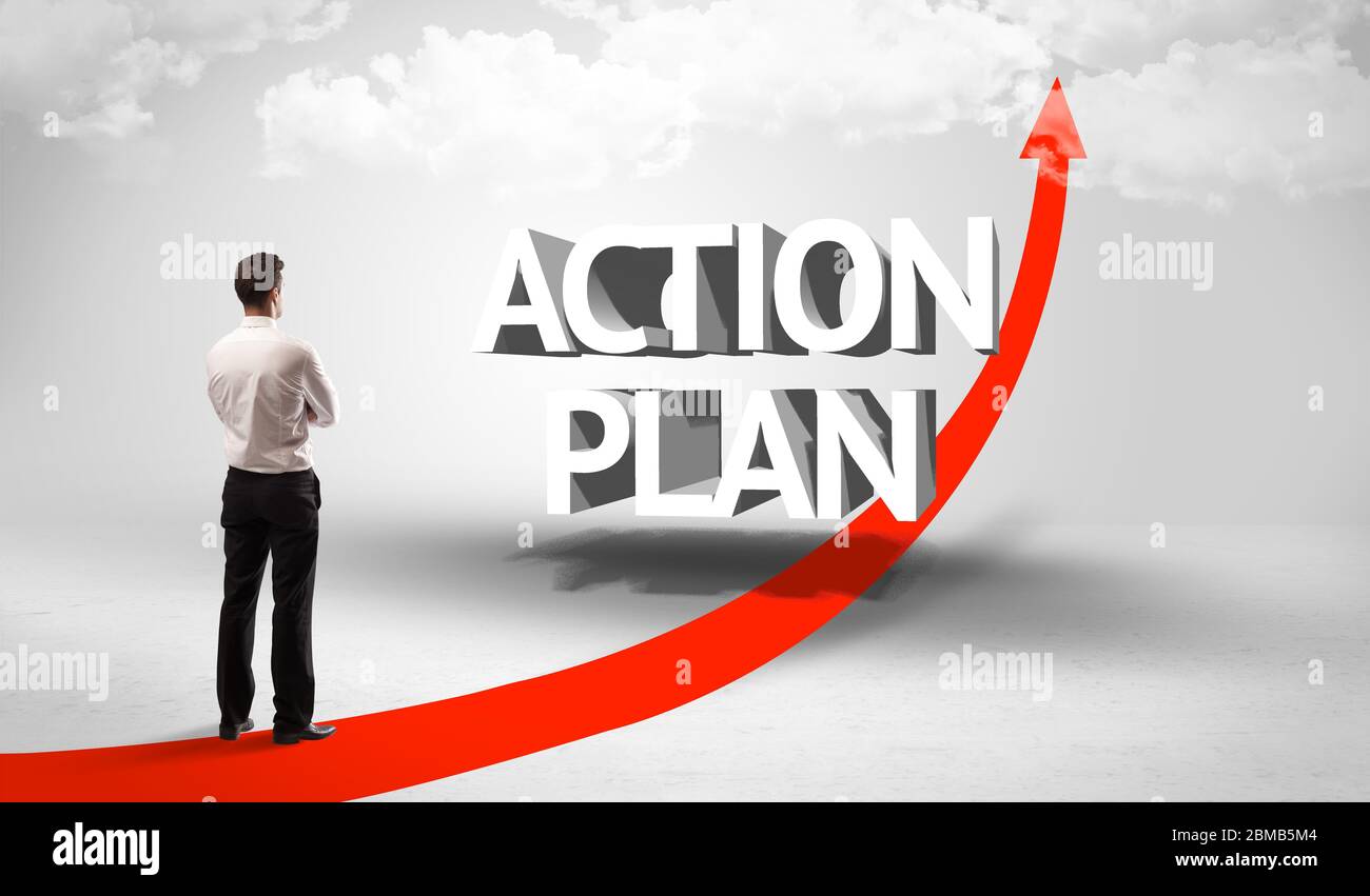 Rear view of a businessman standing in front of ACTION PLAN inscription ...