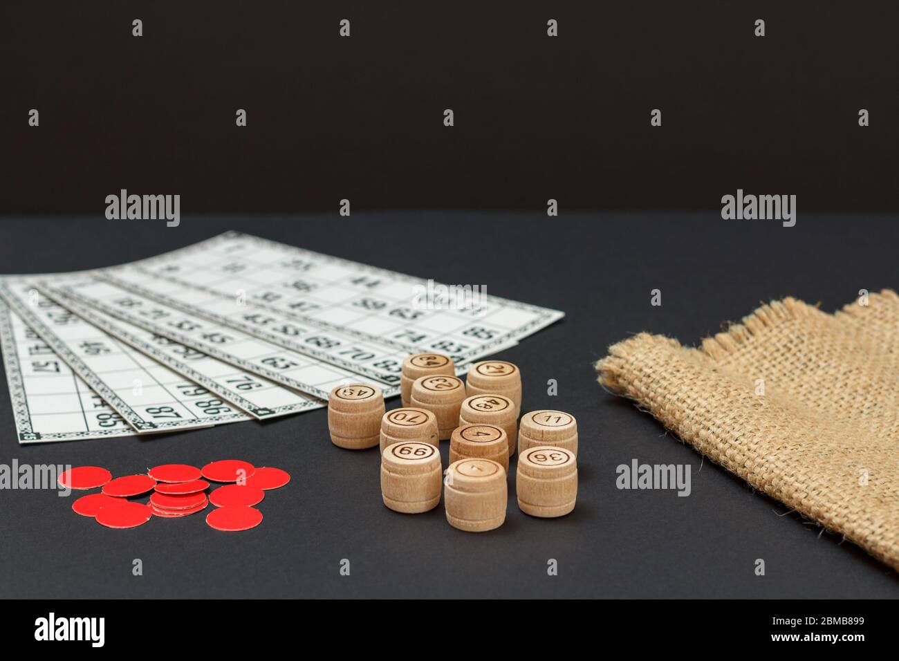 Board game lotto. Wooden lotto barrels with a sackcloth bag, game cards ...