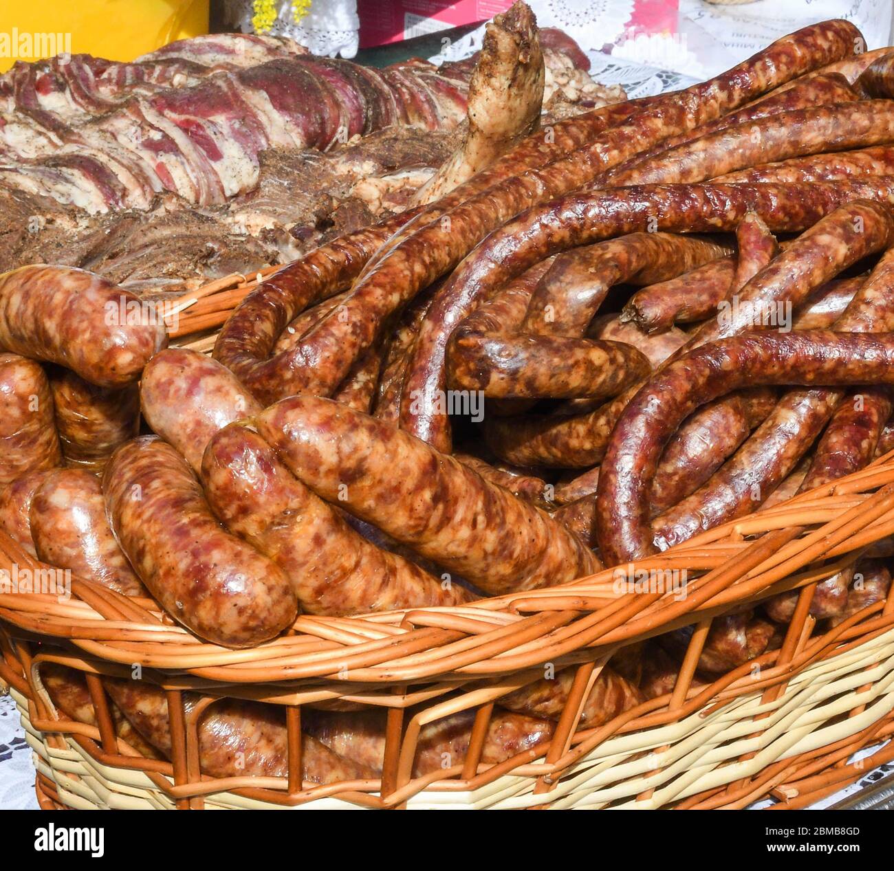 Assorted meat products, sausages, chorizo, spices on a dark table. View ...