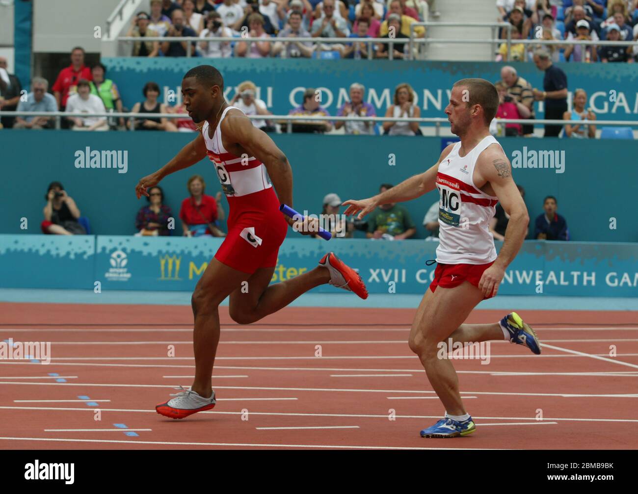MANCHESTER - JULY 31: L-R Darren CAMPBELL of England takes the baton of ...