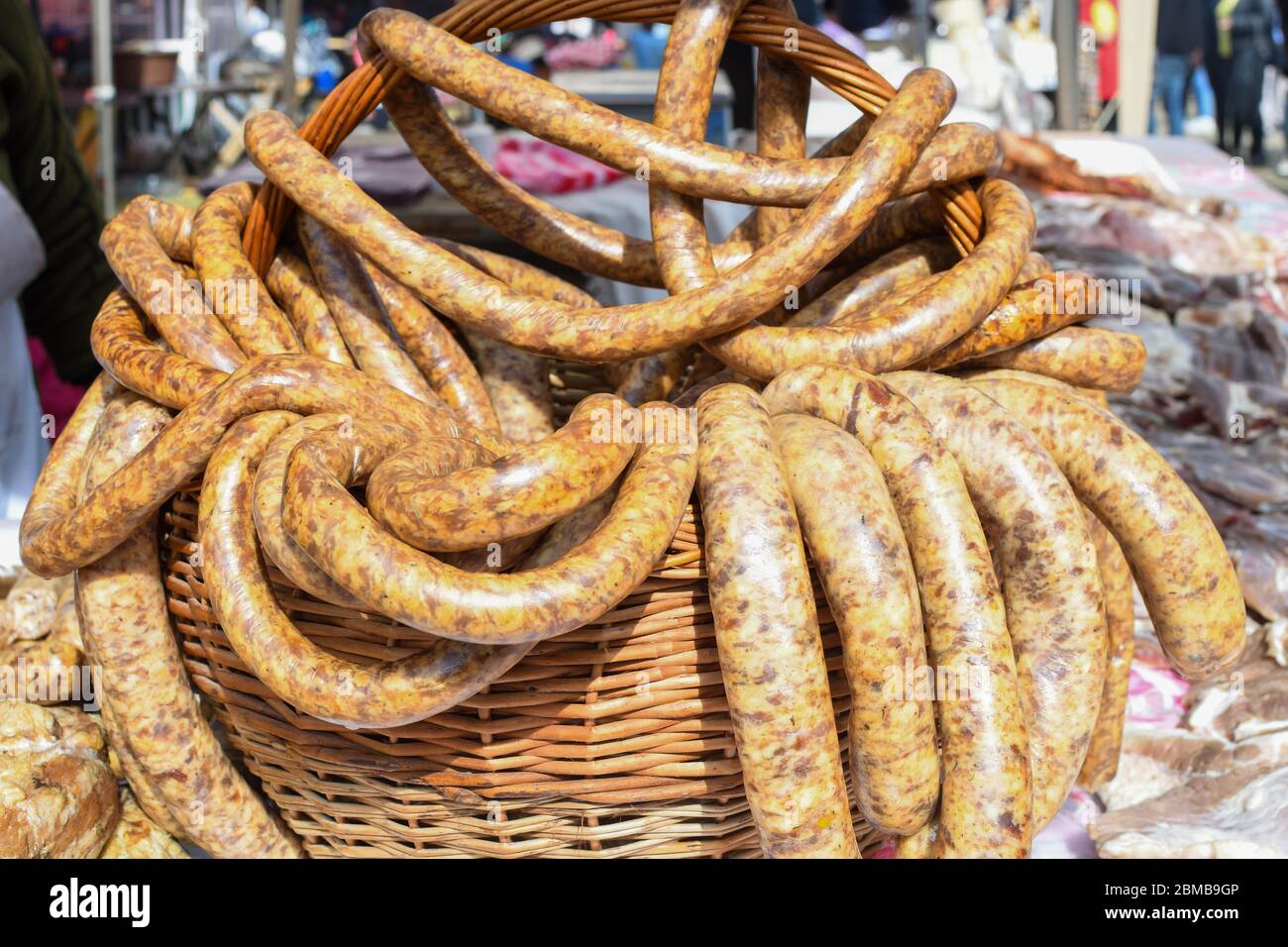 Assorted meat products, sausages, chorizo, spices on a dark table. View ...