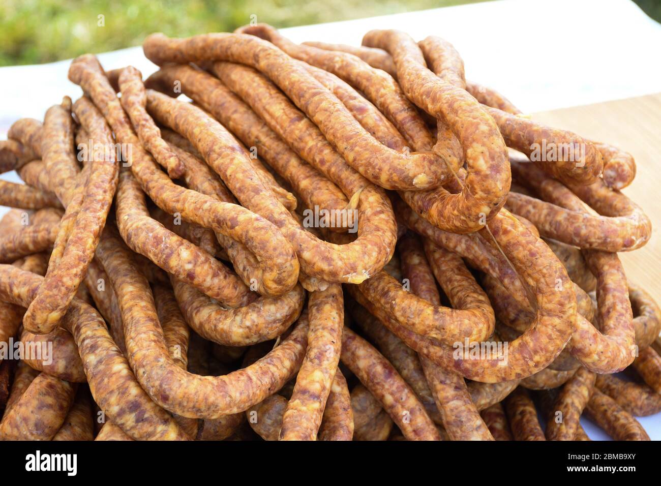 Assorted meat products, sausages, chorizo, spices on a dark table. View ...