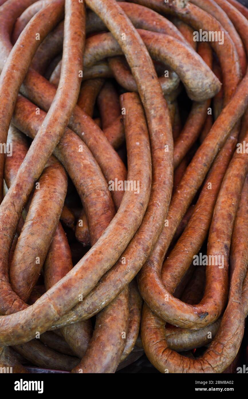 Assorted meat products, sausages, chorizo, spices on a dark table. View ...