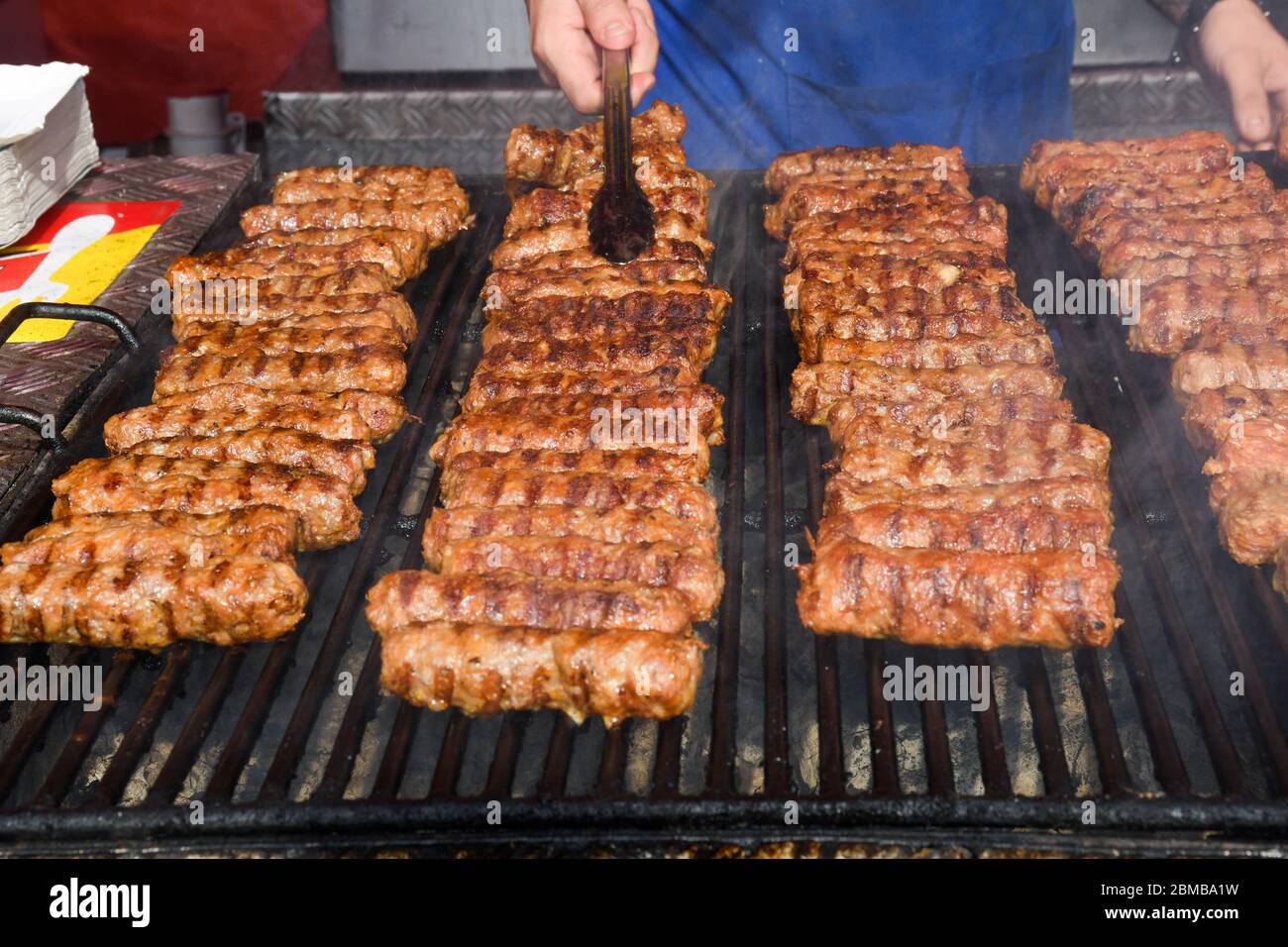 Chef grilling meat during cookout picnic or food event. Meat mix ...