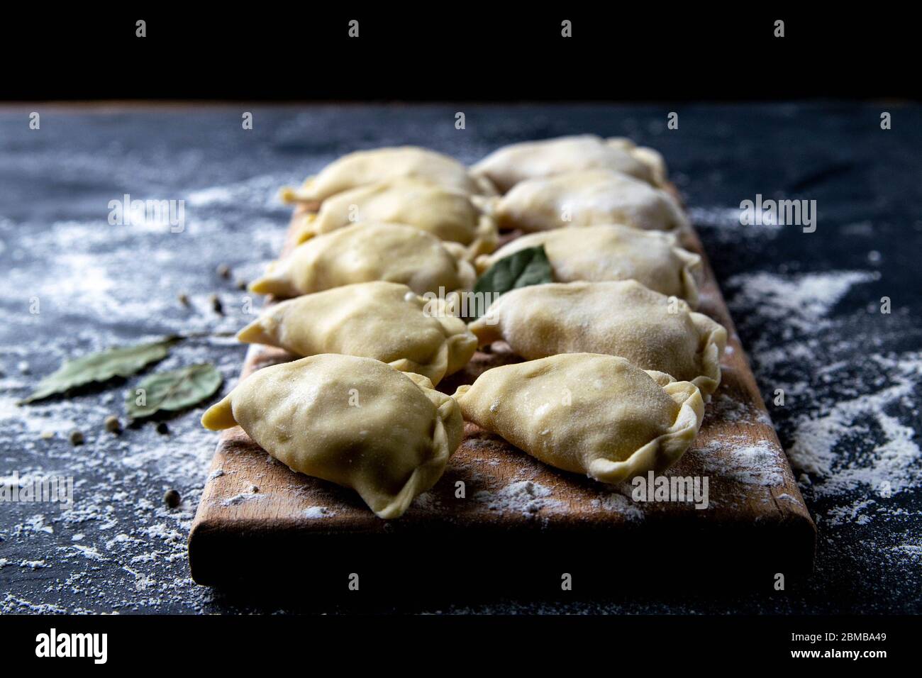 Raw dumpling with potatoes. Preparation dumplings on a wooden board on ...