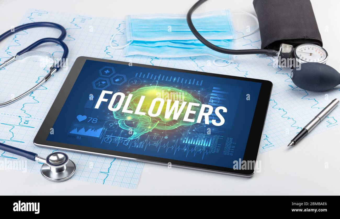 Tablet pc and medical tools with FOLLOWERS inscription, social ...