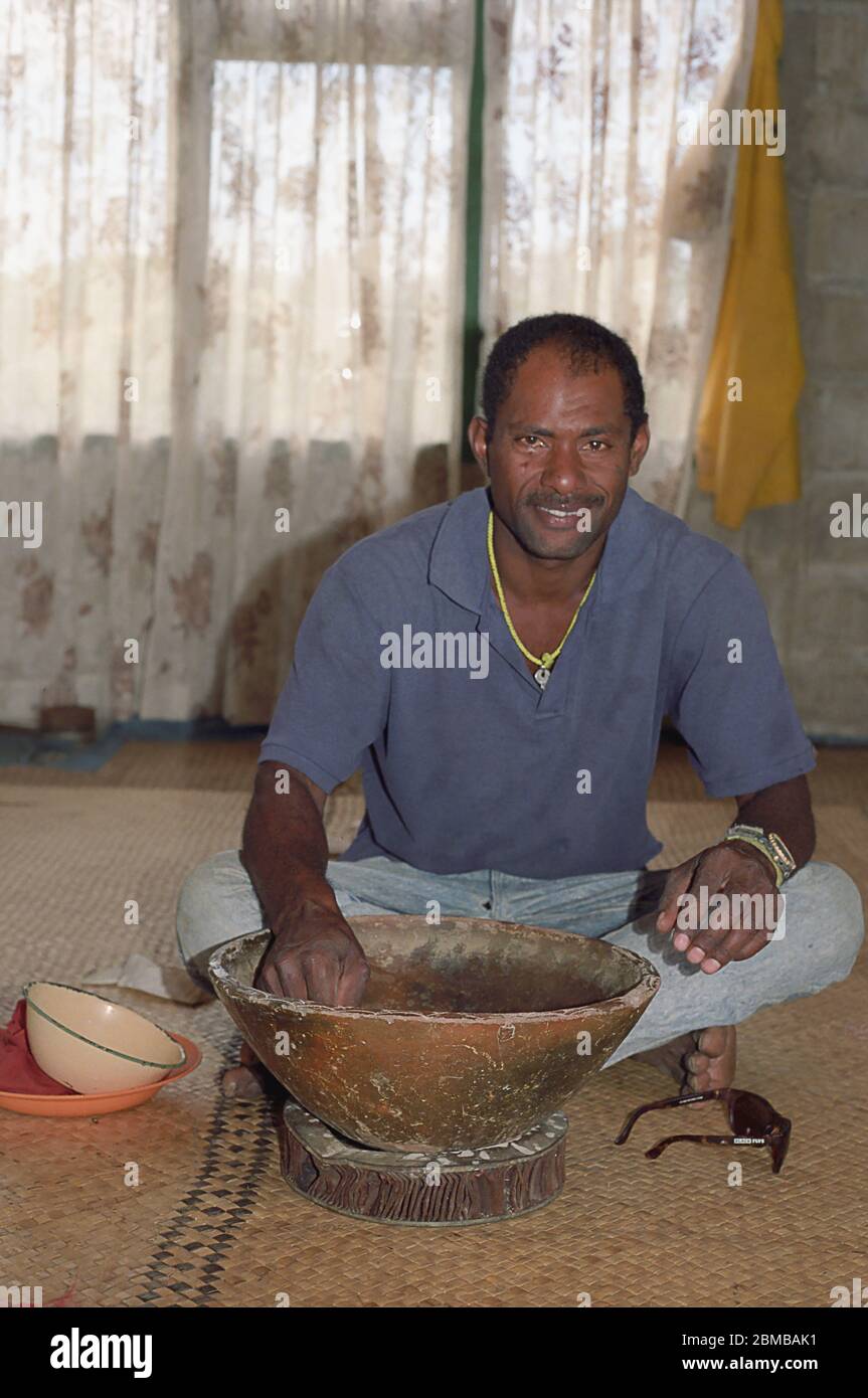 Fijian man performing the yaqona ceremony for visitors to his house ...