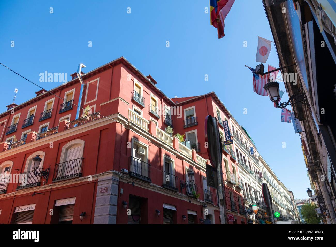 Red building on Pasaje De Mateo street, Madrid, Spain Stock Photo - Alamy