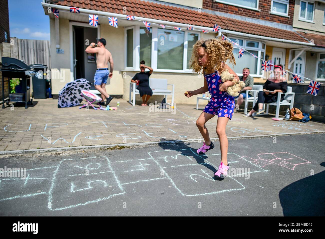 Isla Smith, 5, plays hop-scotch on the pavement outside her home on ...