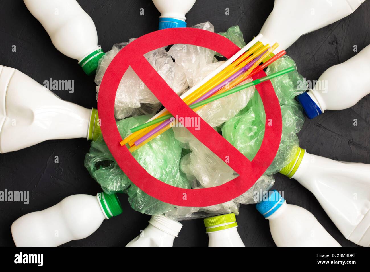 Used plastic bottle and plastic bags with a red forbidden sign on top ...