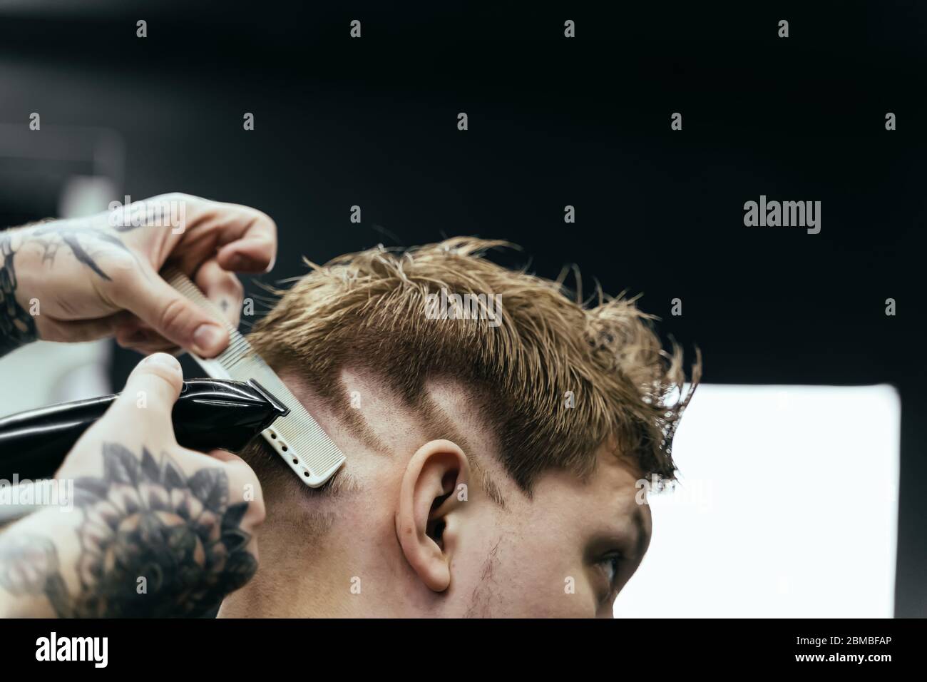 Male barber makes haircut electric hi-res stock photography and images ...