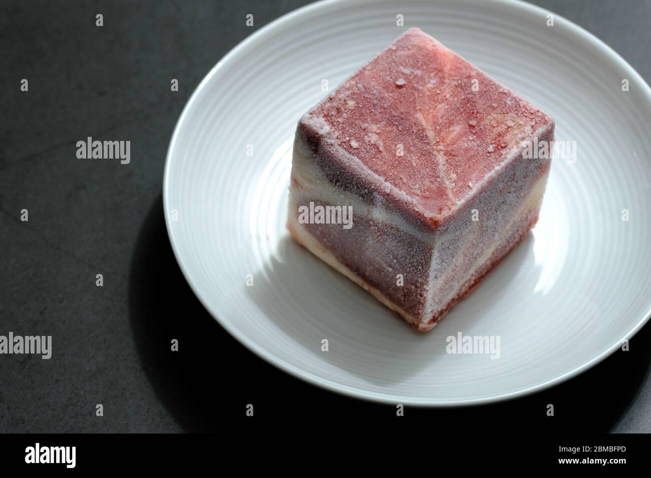 freezing raw beef cubes isolated on white plate Stock Photo - Alamy