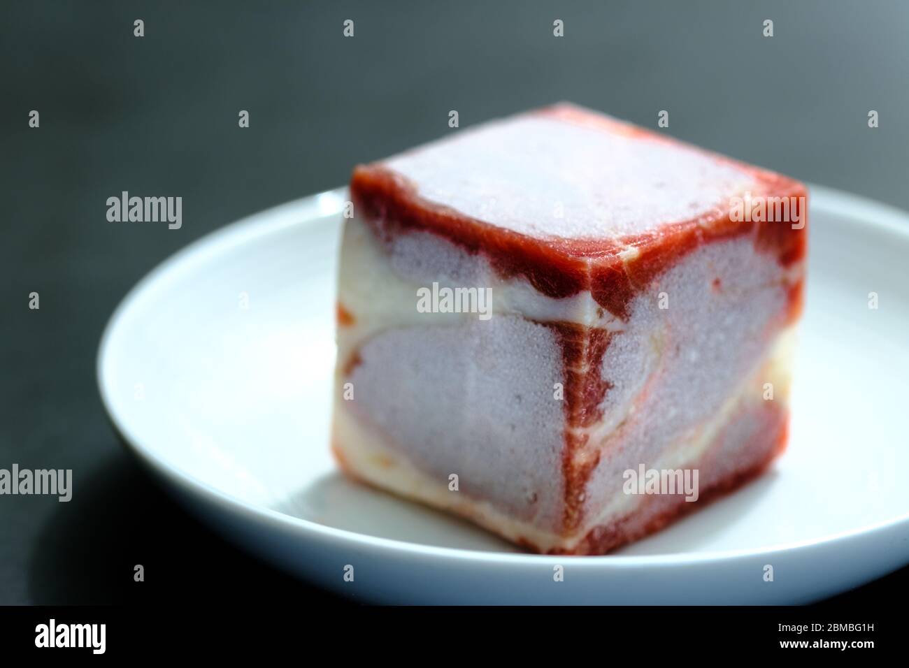freezing raw beef cubes isolated on white plate Stock Photo - Alamy
