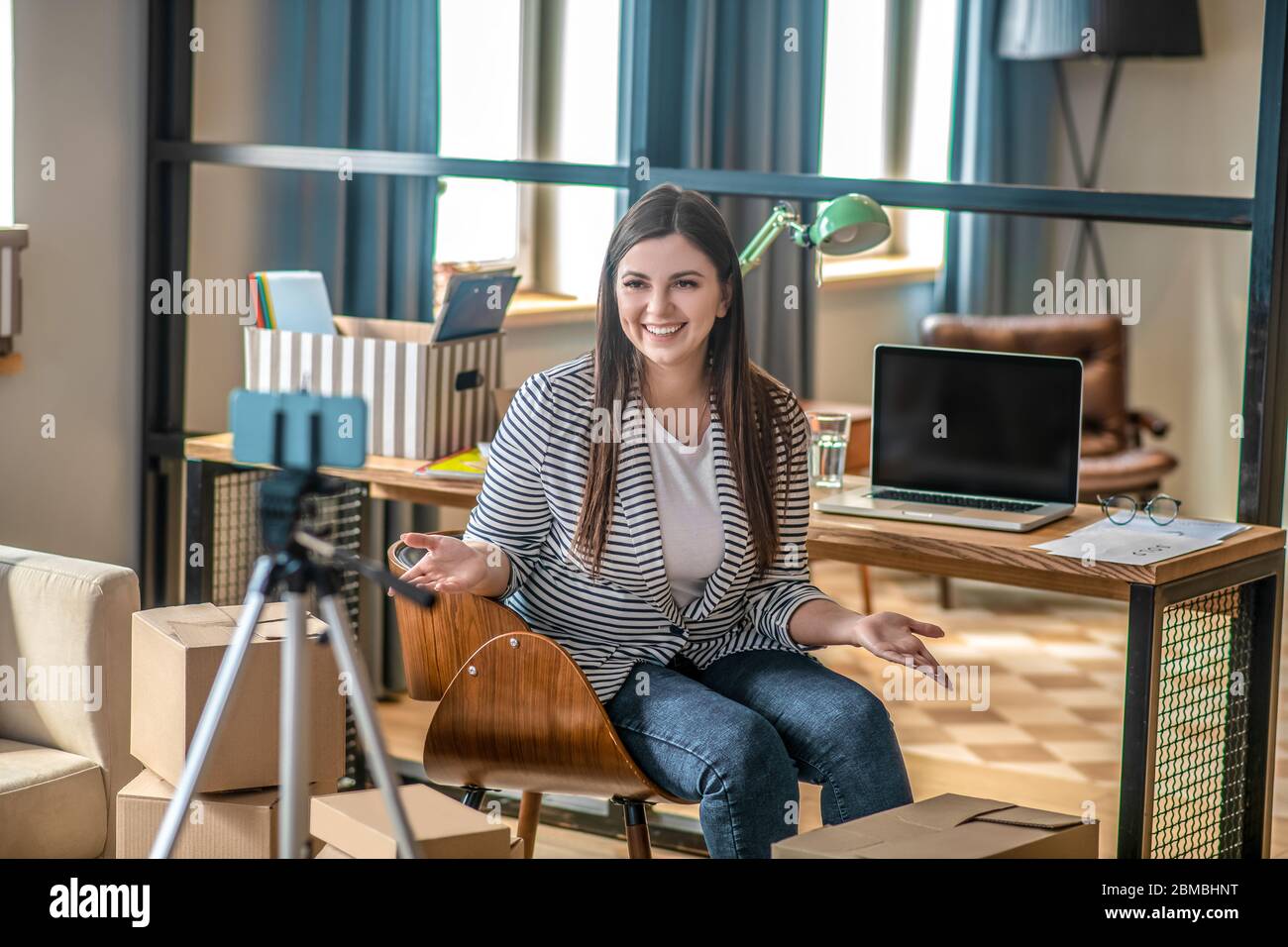 Dark Haired Pretty Young Woman Smiling While Having A Video Conference