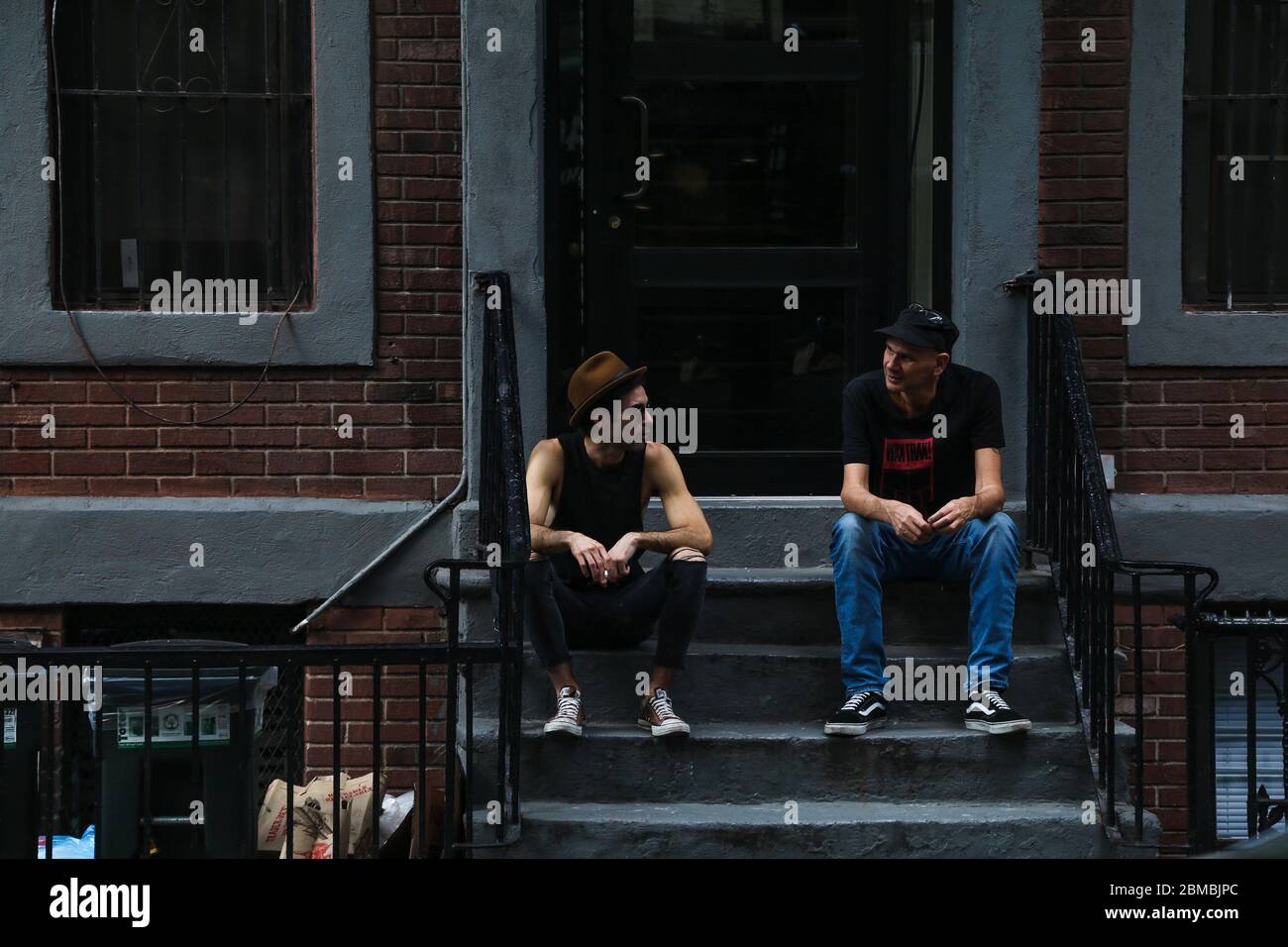 Two Men Sitting On Stairs Talking High Resolution Stock Photography and ...