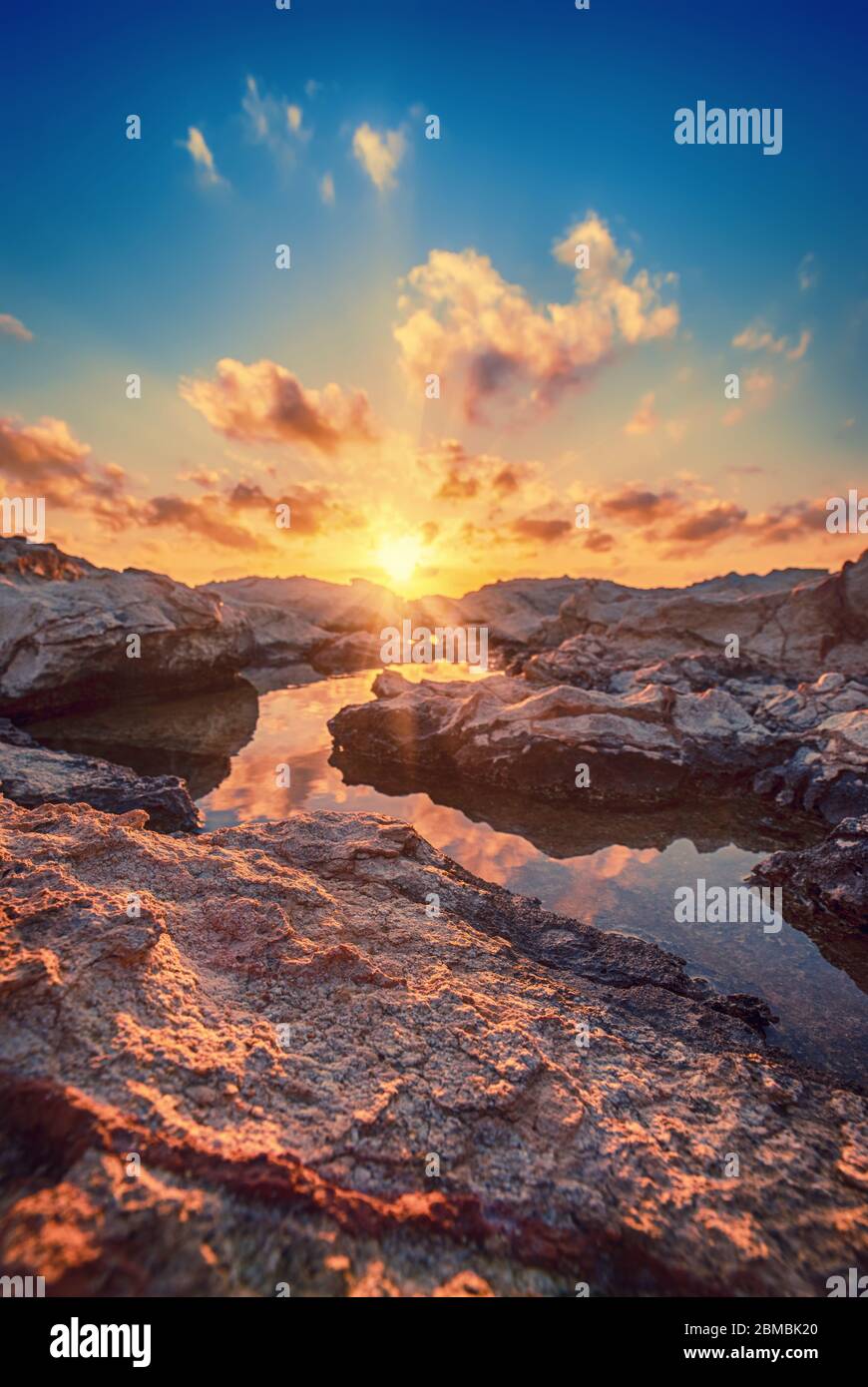 Beautiful colorful sunset near the sea at Cyprus with dramatic clouds ...
