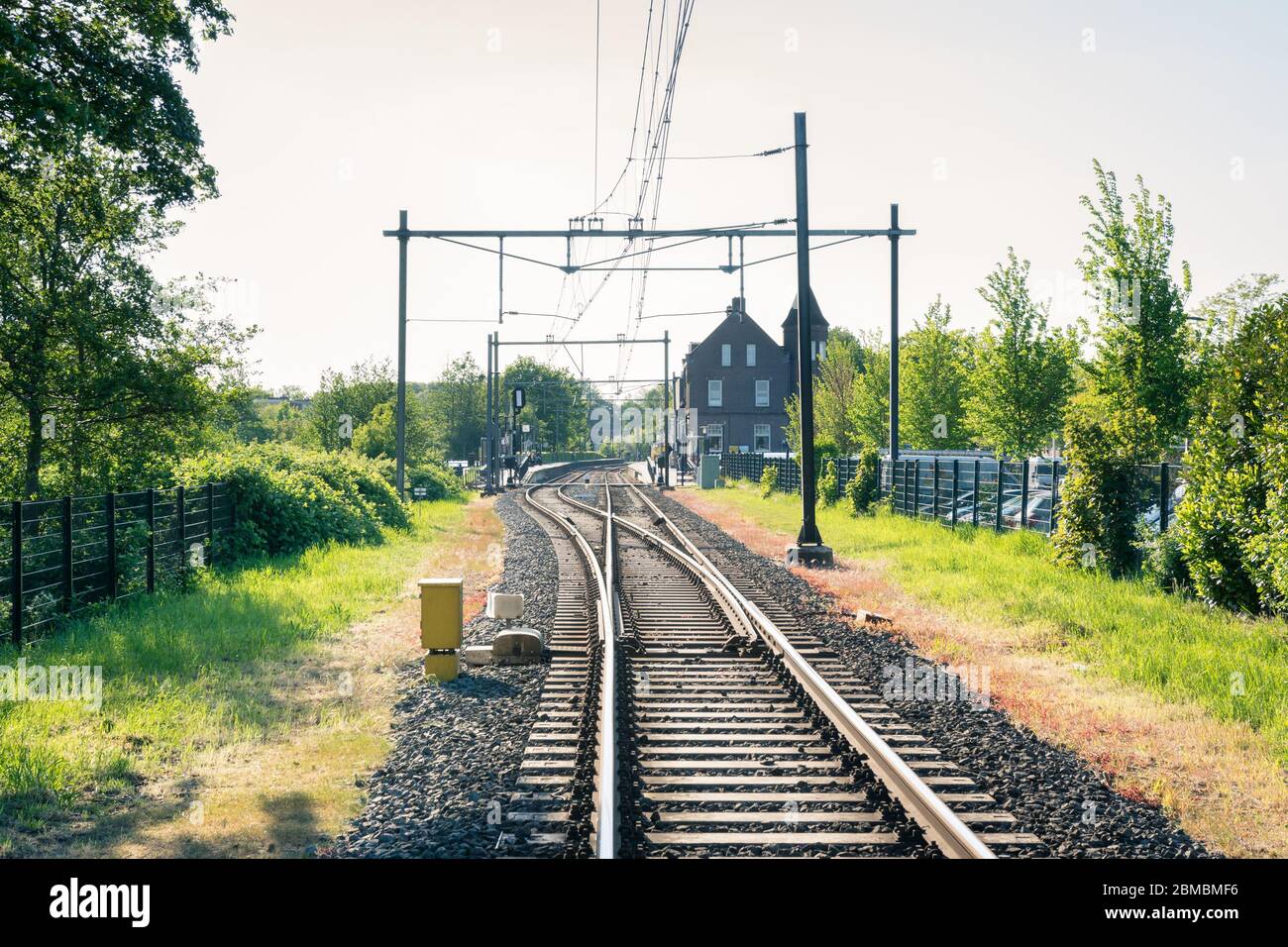 Scenic view of a railroad leading to the train station of Bodegraven ...