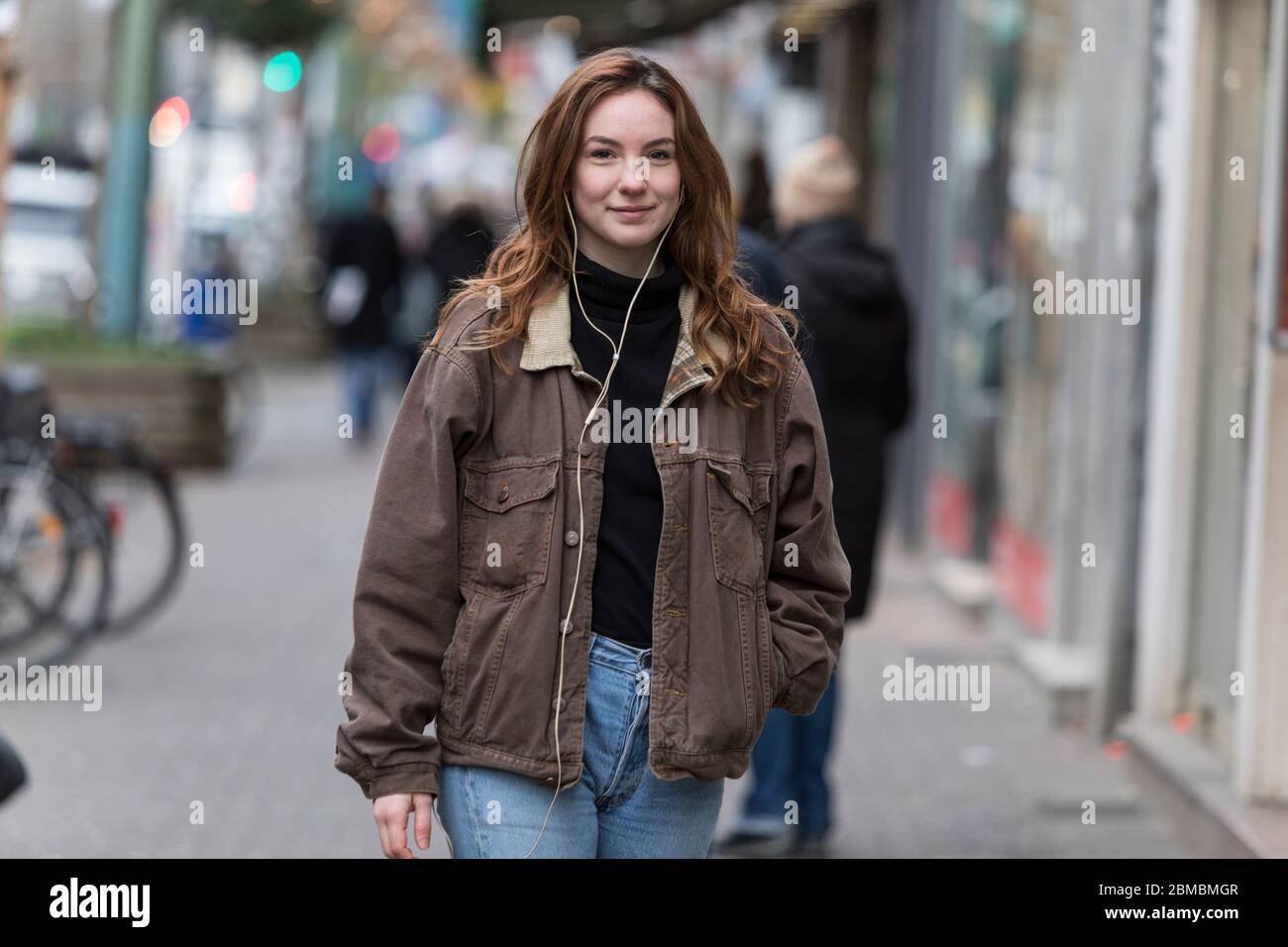 Young Woman Walking and Smiling at Camera Stock Photo - Alamy