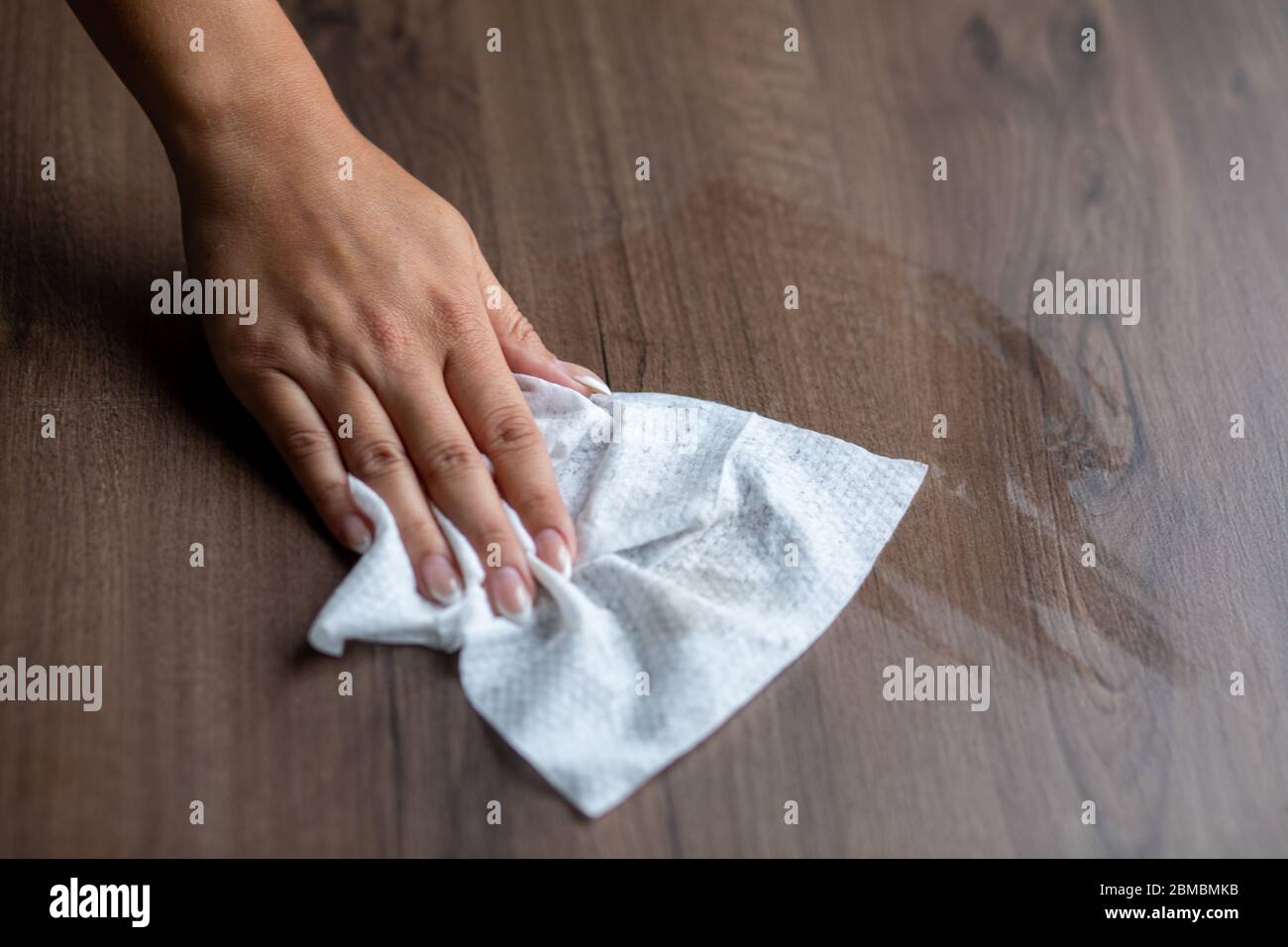 Woman's hand cleaning home office table surface with wet wipes Stock ...
