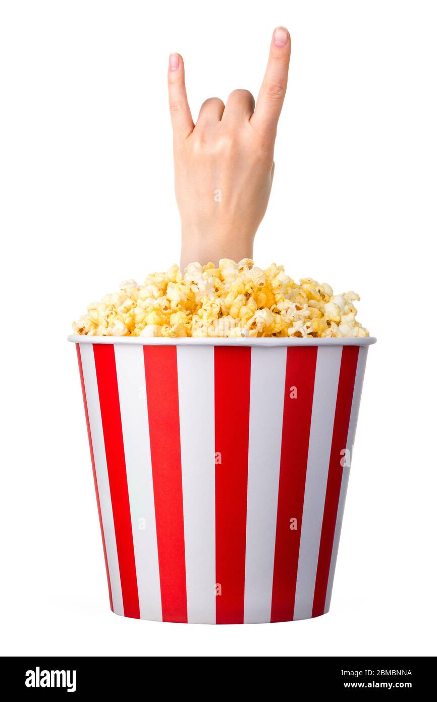 Female hand sticks out of a bucket with popcorn isolated on white ...