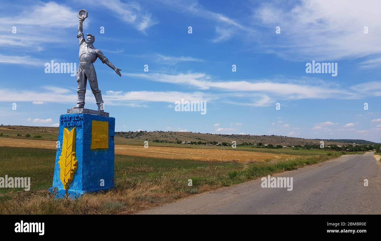 Soviet art statue of worker in powerful pose with sky background ...