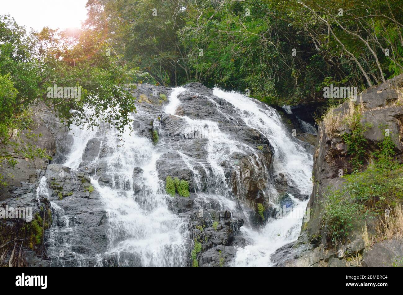 waterfall falling and hit rock splashing to river Stock Photo - Alamy