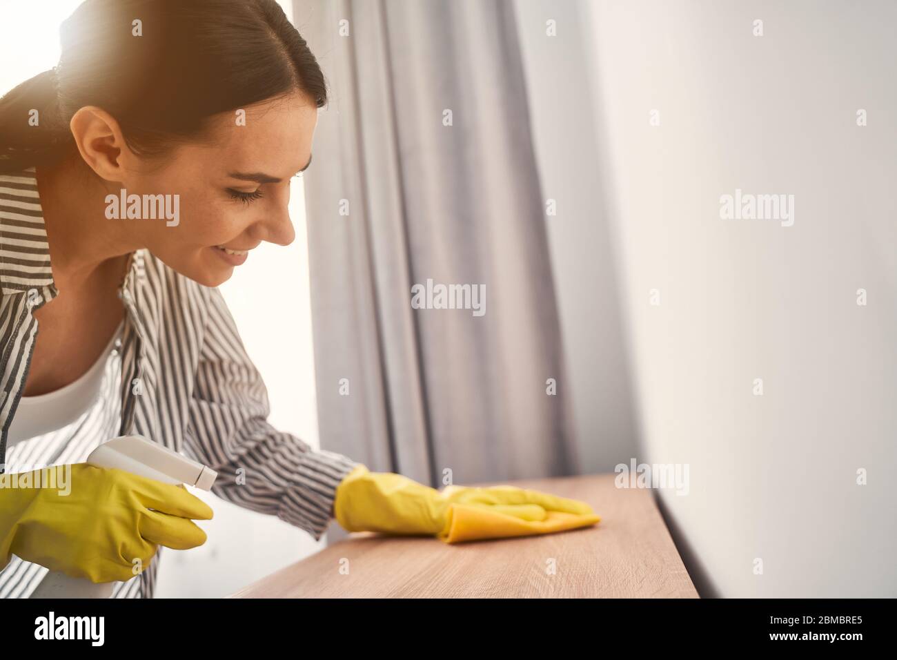 Cheerful young female person keeping her house clean Stock Photo - Alamy