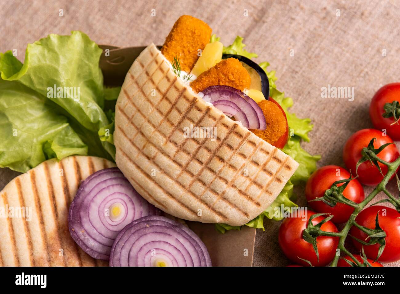 Pita doner kebab with green salad, tomatoes cherry, potato free ...