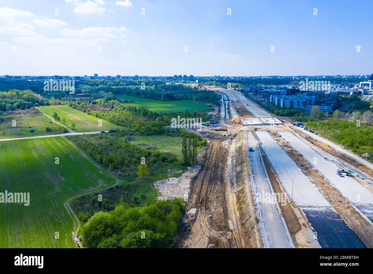 Aerial panorama top down view of an unfinished asphalt covered road ...