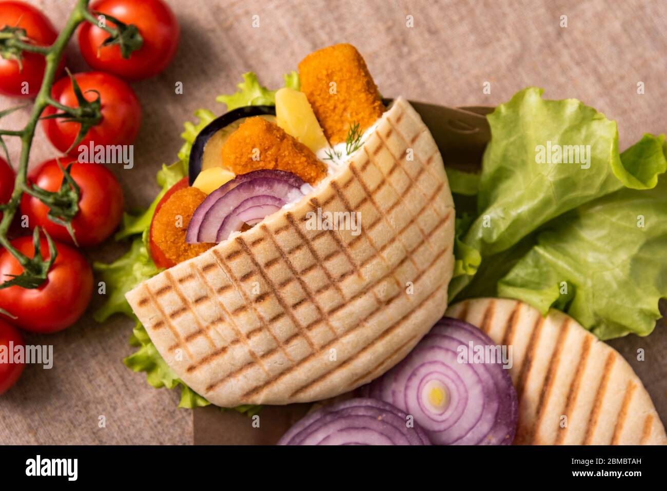 Pita doner kebab with green salad, tomatoes cherry, potato free ...