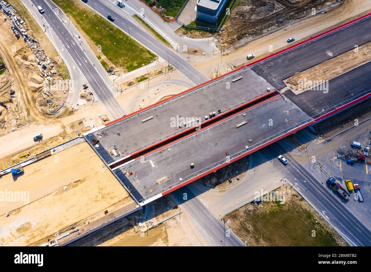 Aerial panorama top down view of an unfinished asphalt covered road ...