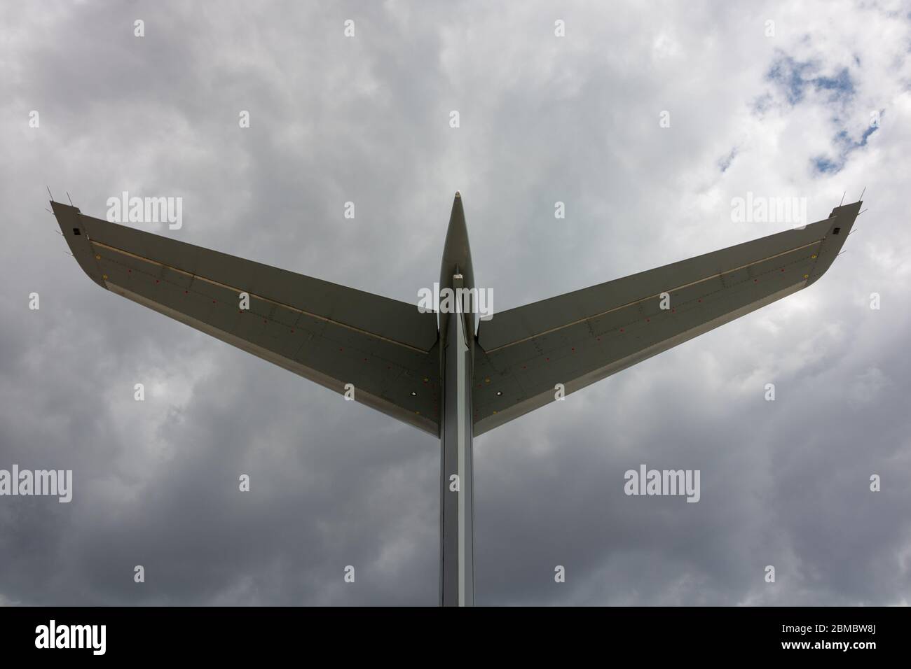 Tail of military aircraft with cloudy sky Stock Photo - Alamy