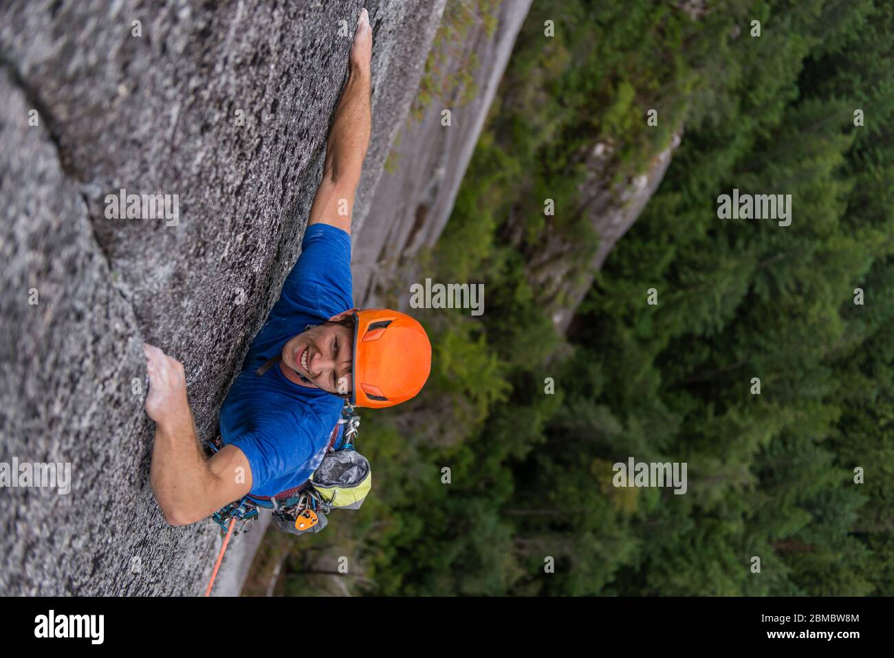 Climber smiling while trad climbing multipitch route in Squamish Stock ...