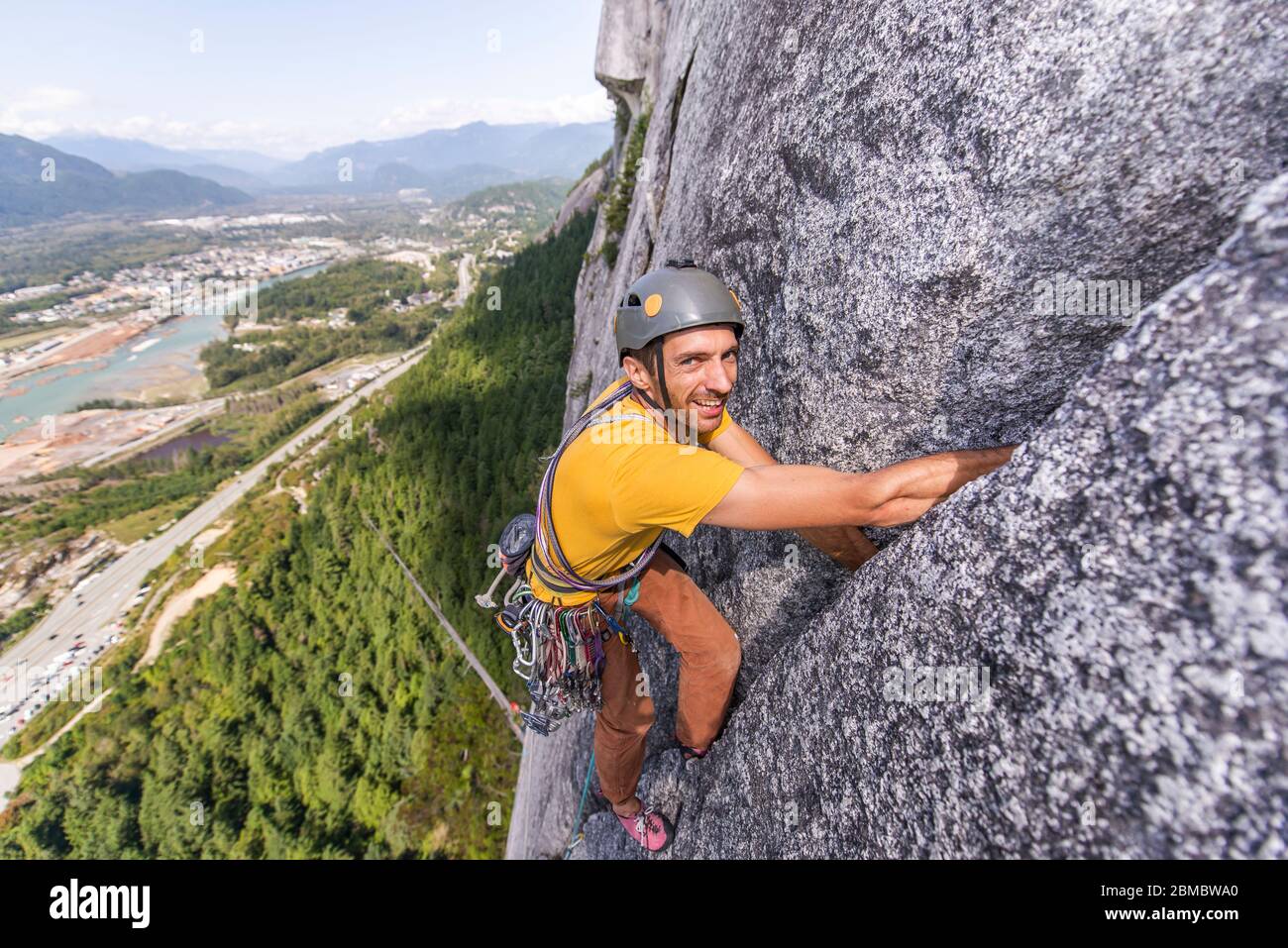 Man looking at camera while climbing multipitch on granite Squamish ...